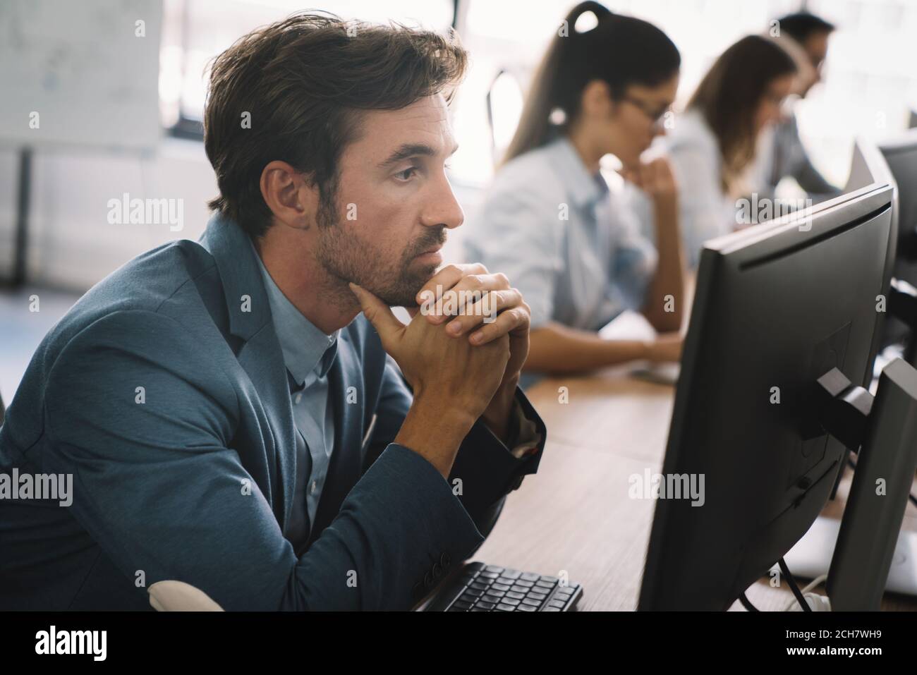 Creative people working in office on computer Stock Photo - Alamy