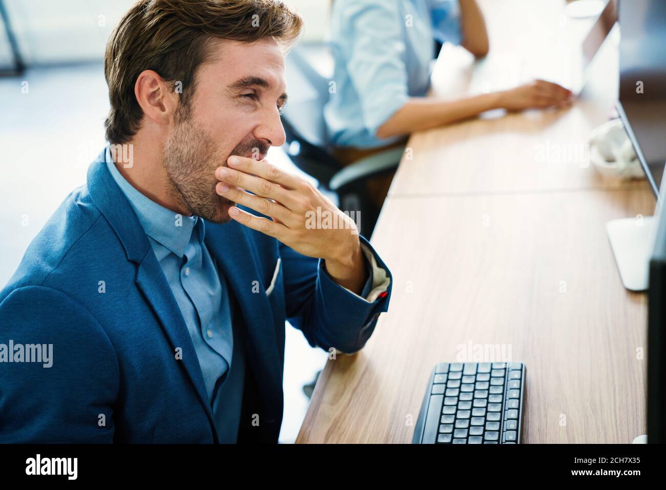 Overworked tired employee at workplace in office being unhappy Stock ...
