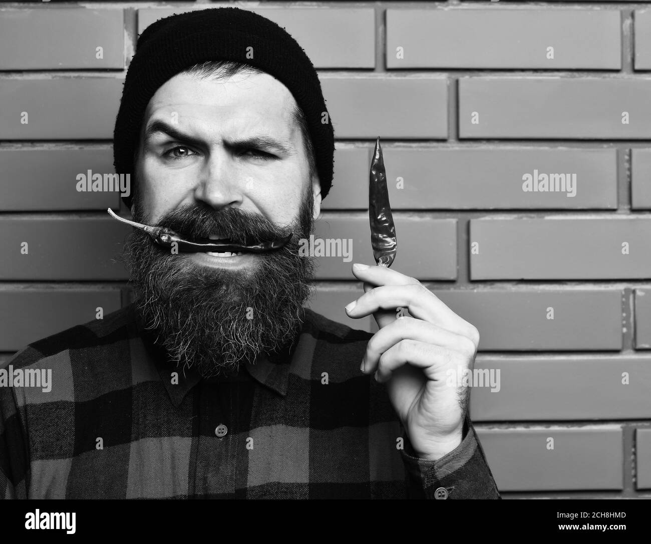 Man holding red chilli Black and White Stock Photos & Images - Alamy