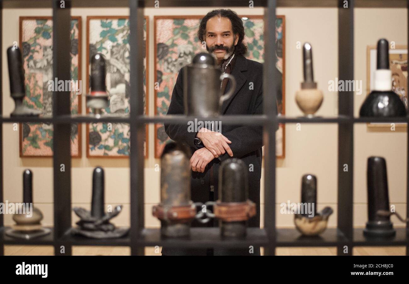 Artist Hew Locke stands behind the work of his father, Donald Locke ...