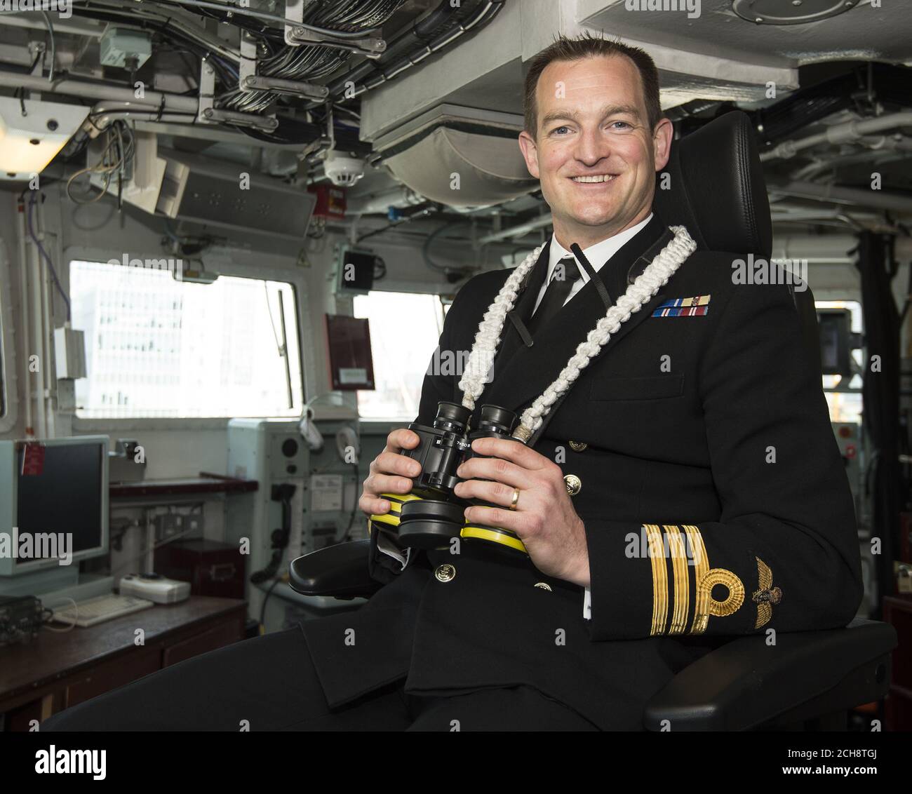 Commanding Officer Daniel Thomas in the bridge of HMS Kent as she docks ...