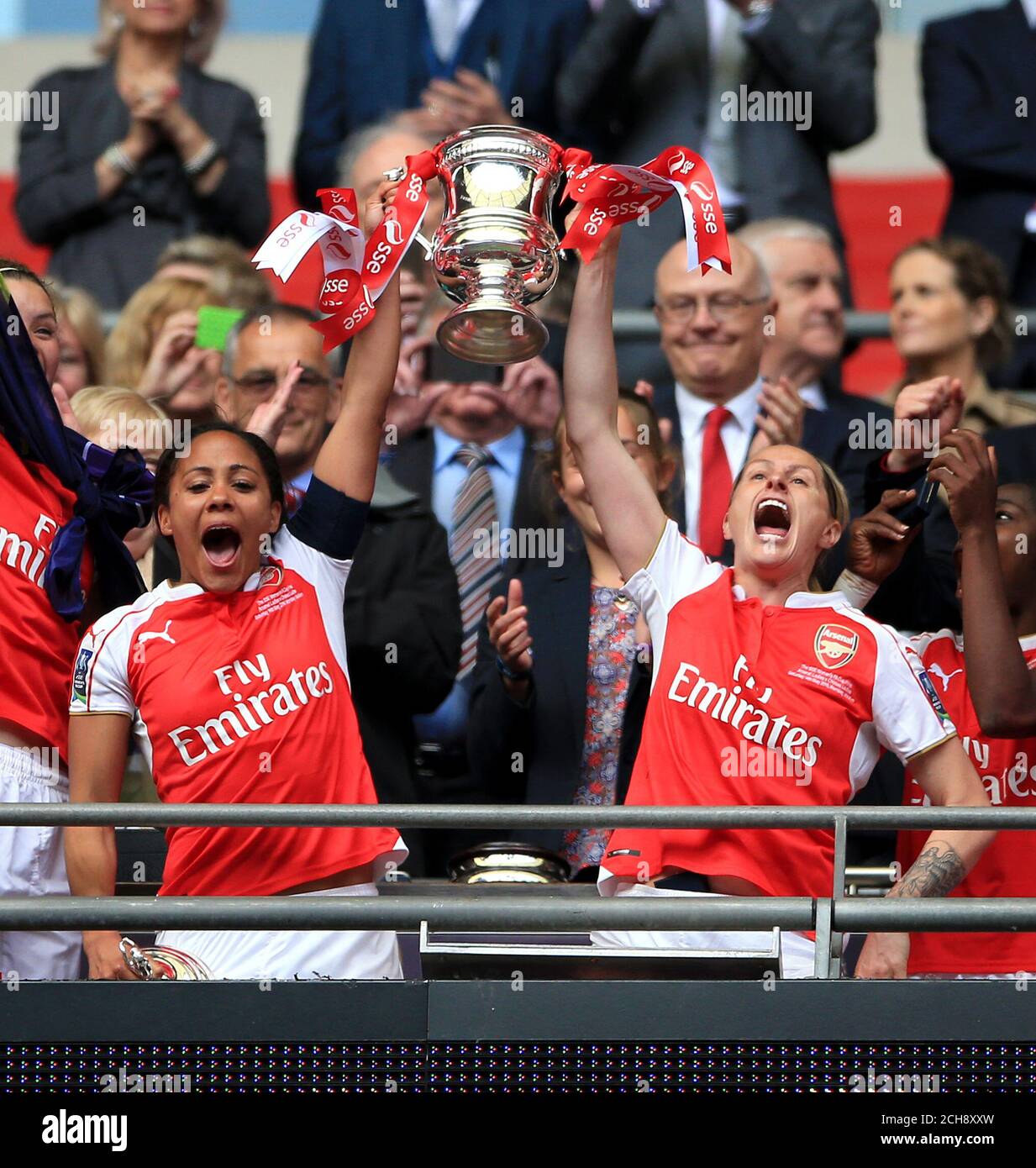 Arsenal's Alex Scott (left) and Kelly Smith lift the trophy and ...