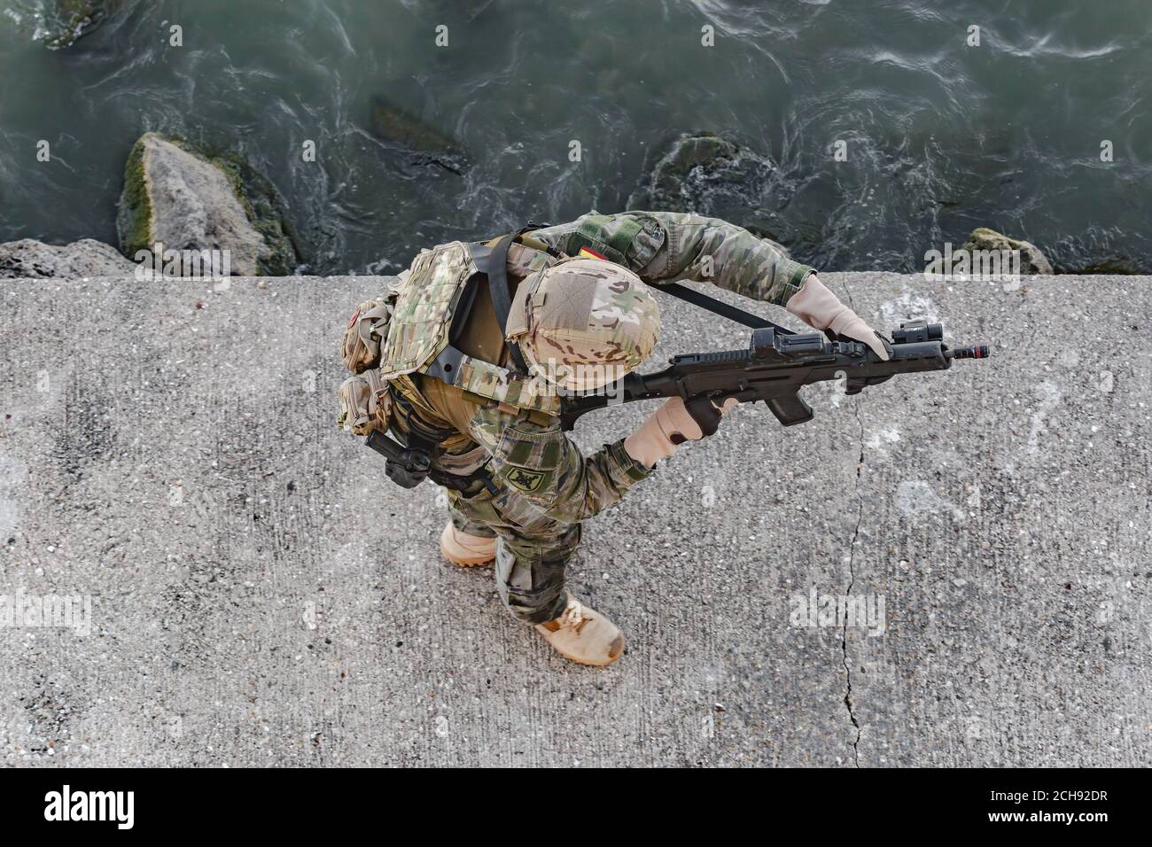 Army soldier in Combat Uniforms with assault rifle. Military equipment ...