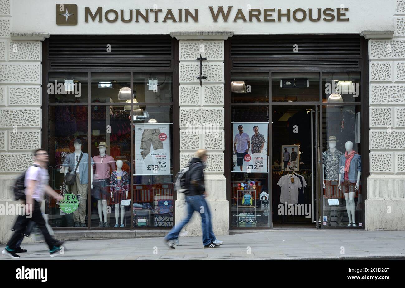 Shoppers pass a mountain warehouse store in central london hi-res stock ...