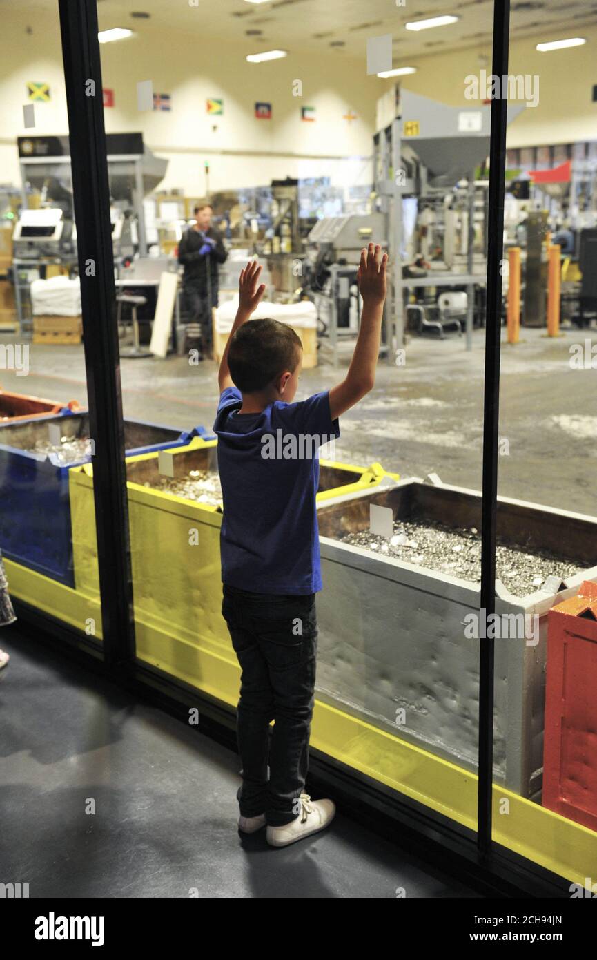 EDITORIAL USE ONLY Mason Waite views the Coin Press Room during a visit ...