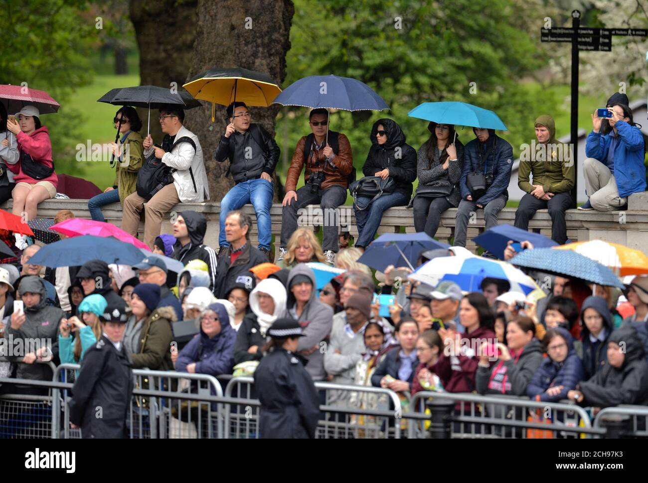 The crowd waits for the royal procession near Buckingham Palace, London ...