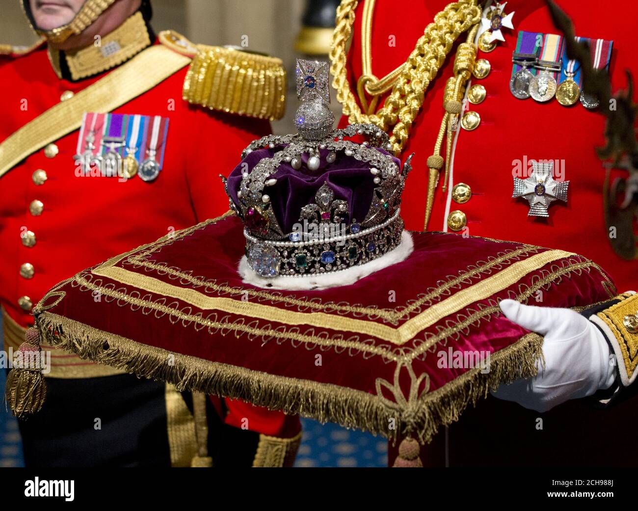Queen Elizabeth II's Imperial State Crown is carried through Norman ...