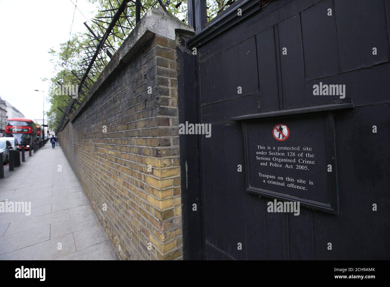 A sign warns against trespass on a gate in the wall surrounding ...