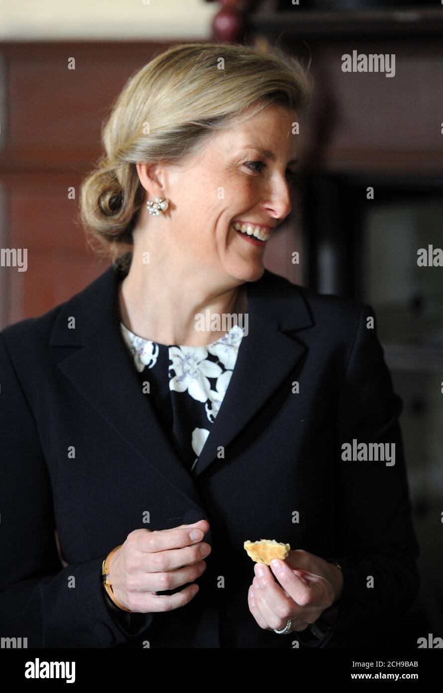 The Countess of Wessex tries some Welsh cake during a visit to Cogges ...