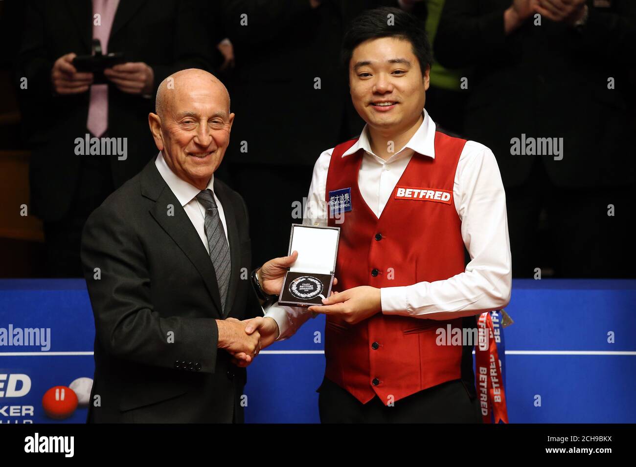 China's Ding Junhui (right) is presented with his runners up medal by ...