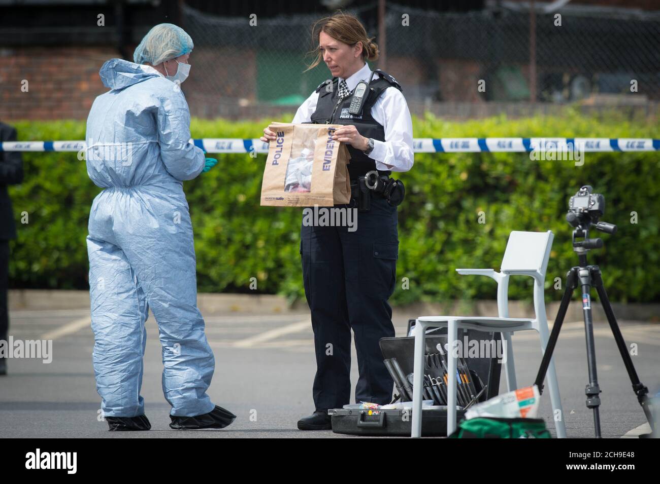 Police and forensic officers holding an evidence bag hi-res stock ...