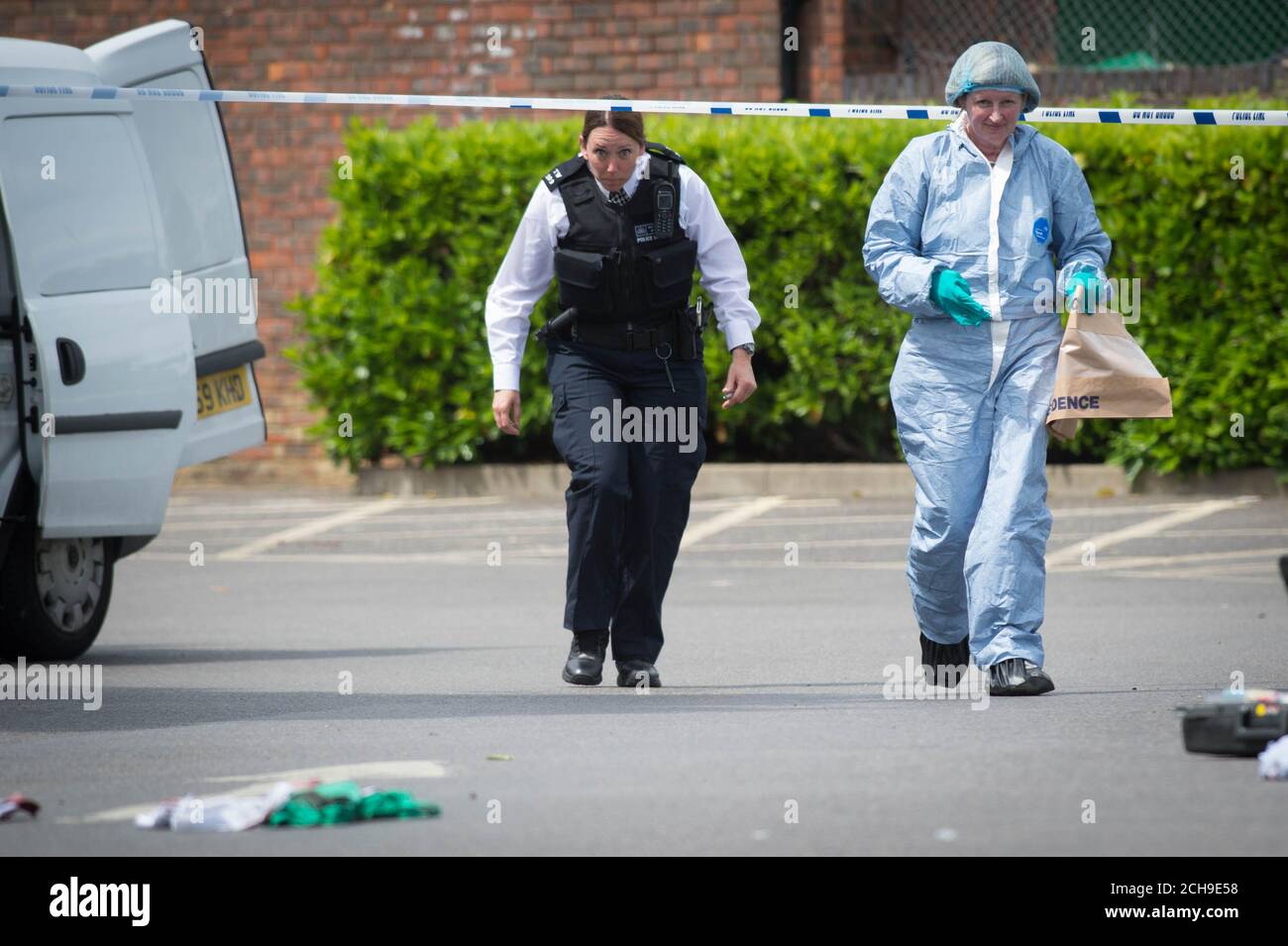 Police and forensic officers holding an evidence bag hi-res stock ...