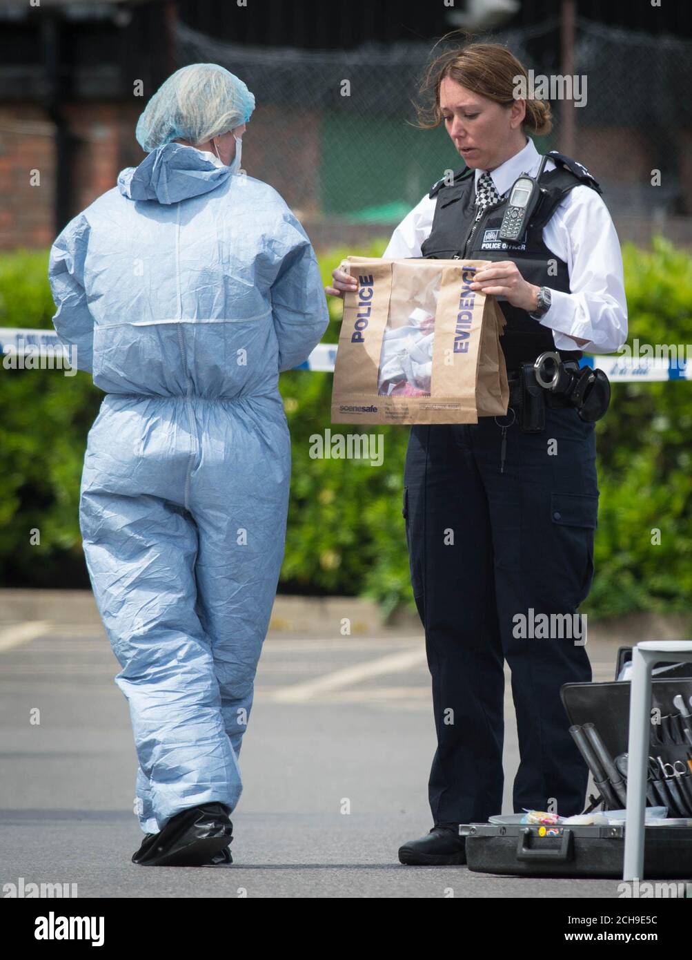 Police and forensic officers holding an evidence bag hi-res stock ...