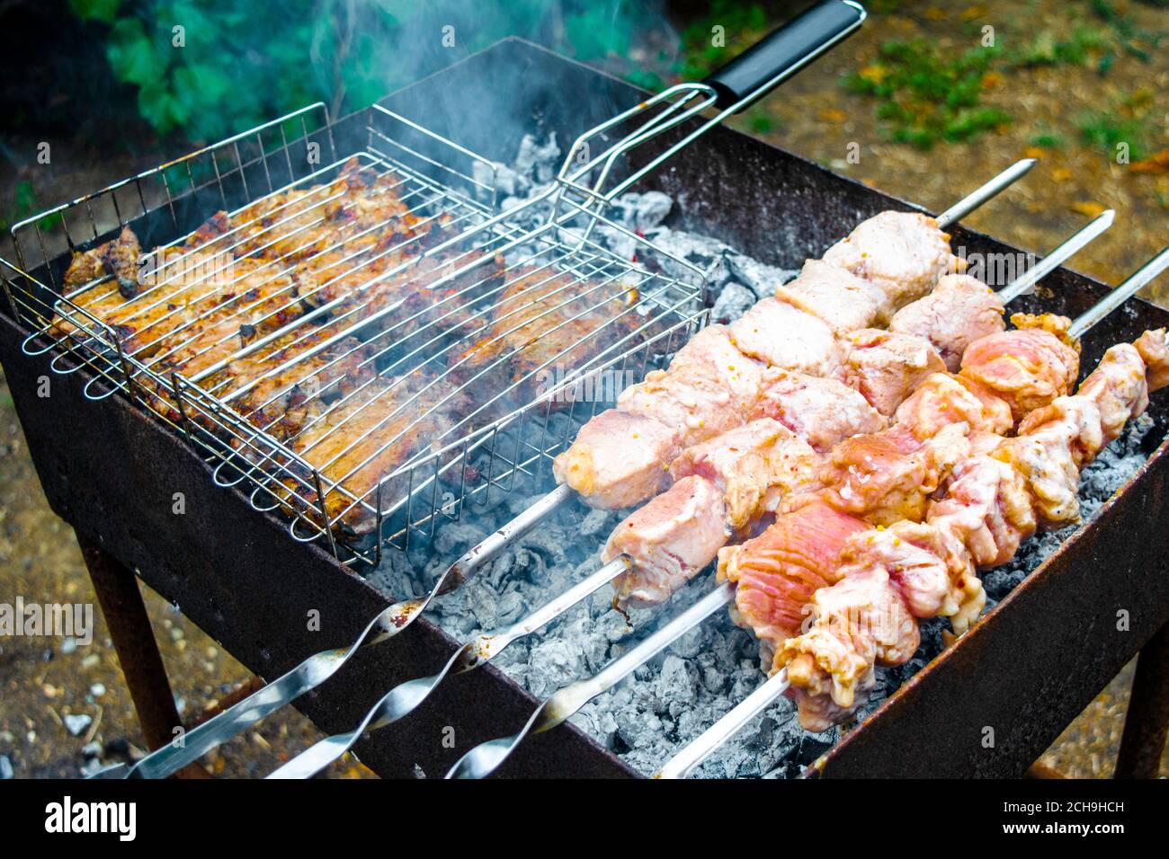 grilled meat on the charcoal grill. Embers smoke ash Stock Photo - Alamy