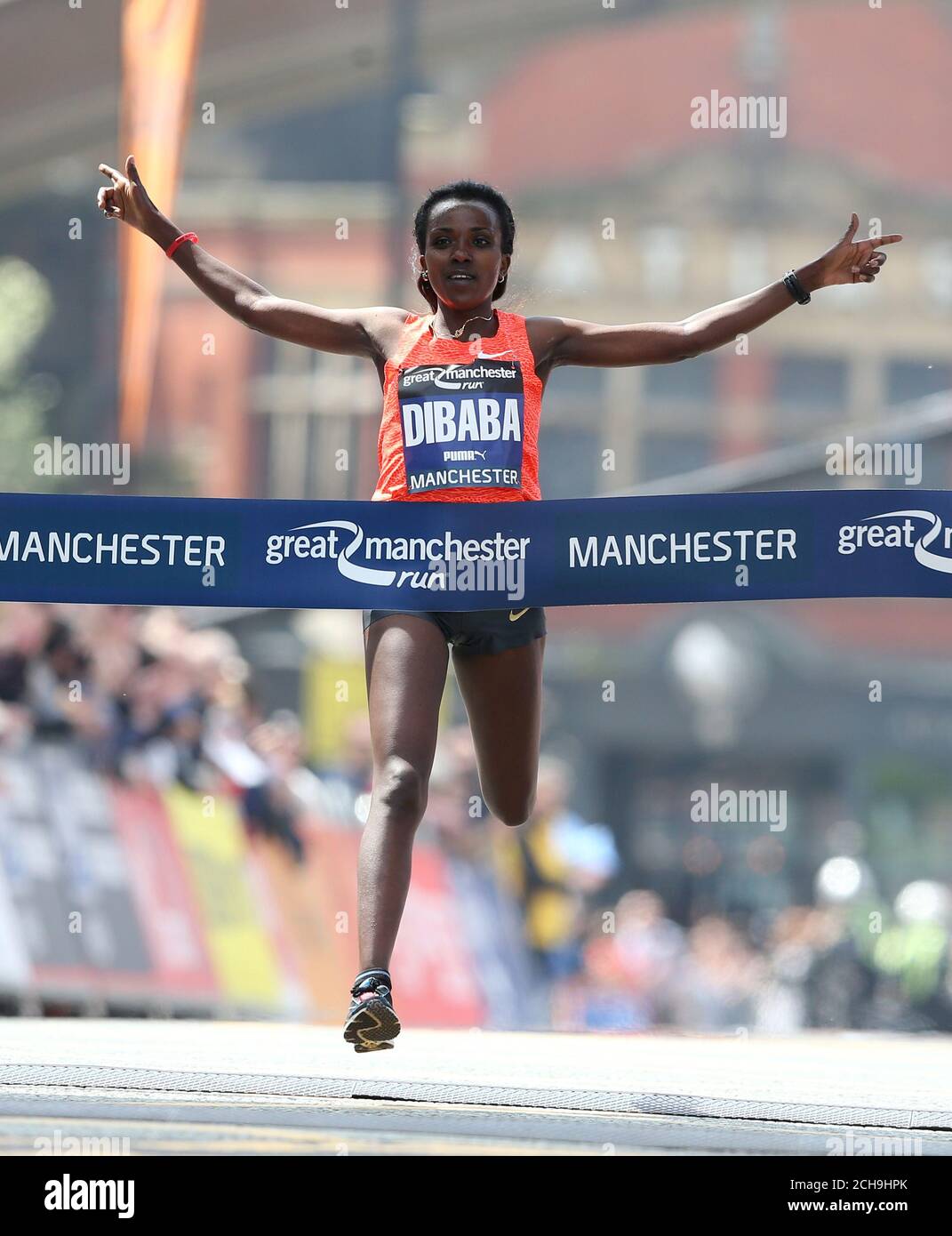 Ethiopa's Tirunesh Dibaba crosses the line to win the Women's race ...