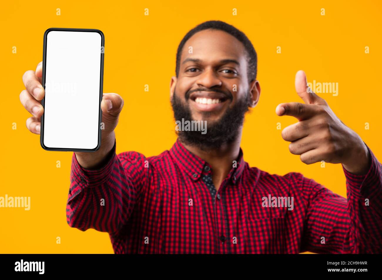 Afro guy showing blank cell phone screen Stock Photo - Alamy