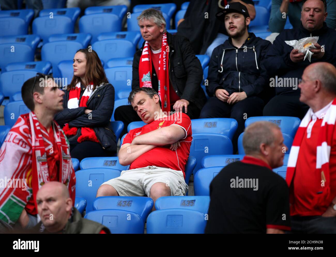 A Liverpool fan falls asleep in the stands Stock Photo - Alamy