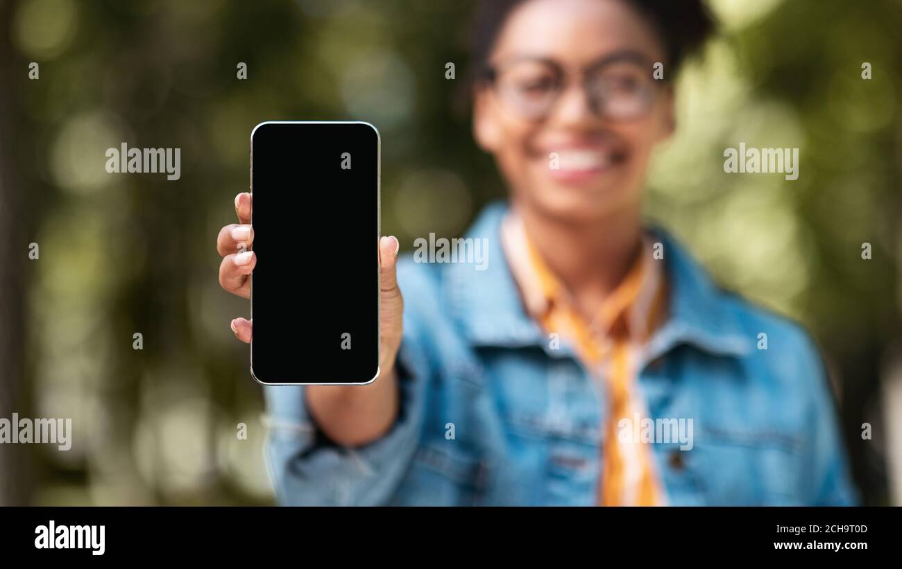 African Student Girl Showing Smartphone Screen Standing In Park ...