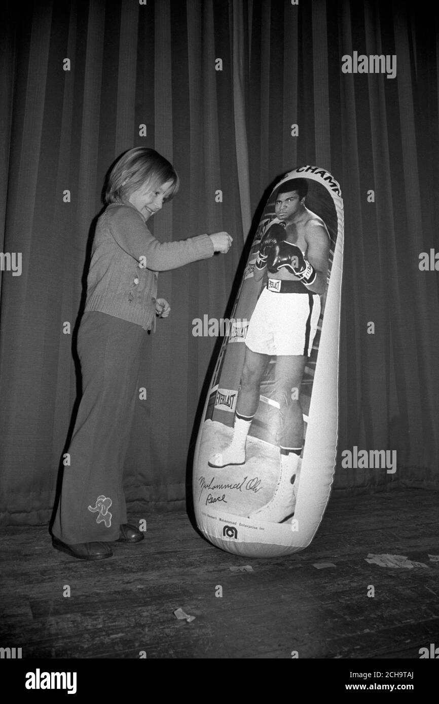 A child enjoys playing with a Muhammad Ali inflatable punching bag at ...