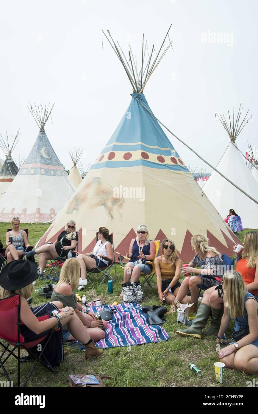Festival goers relax in the tipi field at the Isle of Wight Festival ...