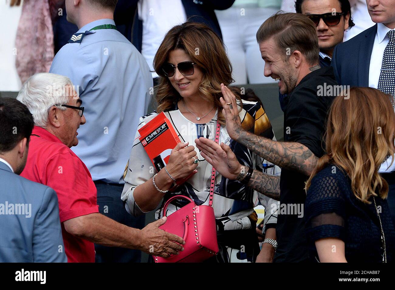 Mirka Federer and Robert Federer (left) speak with David Beckham on day ...
