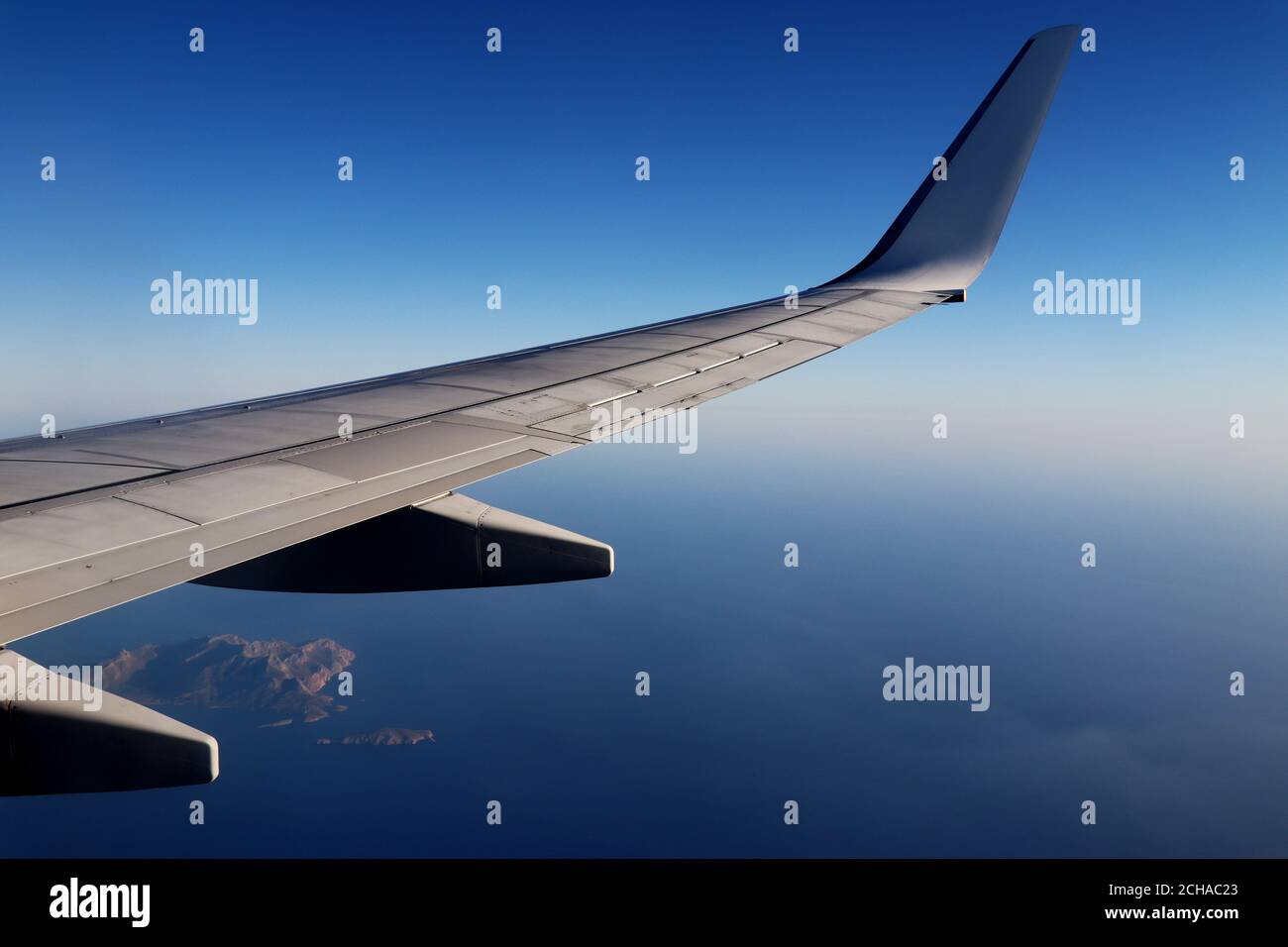 Plane wing over the ocean with islands Stock Photo - Alamy