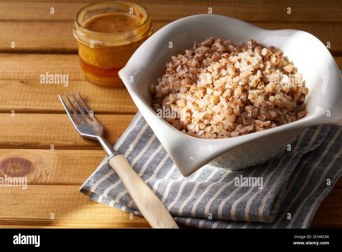 Boiled buckwheat porridge with butter served in a plate Stock Photo - Alamy