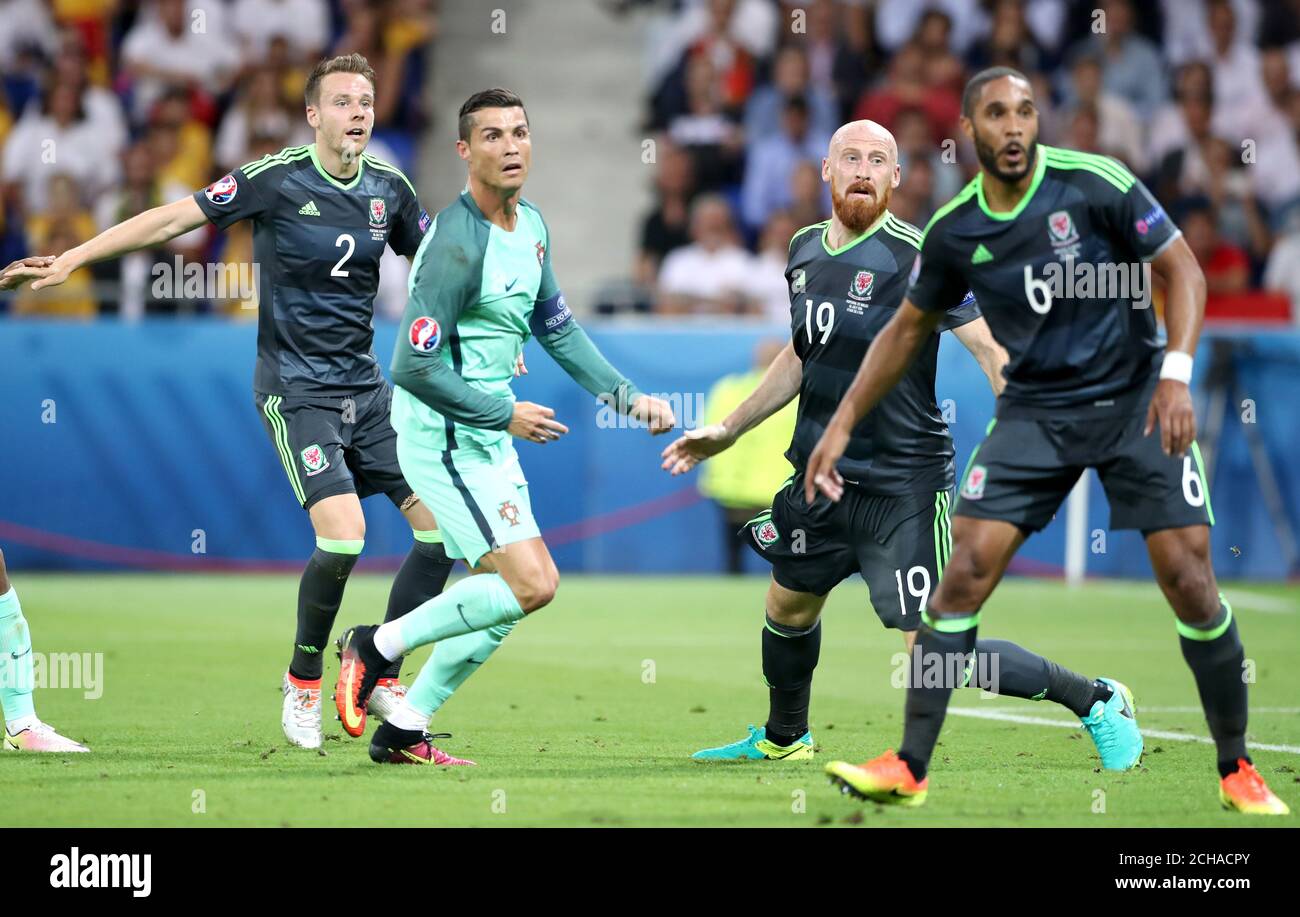 Portugal's Cristiano Ronaldo is closely watched by Wales' Chris Gunter ...