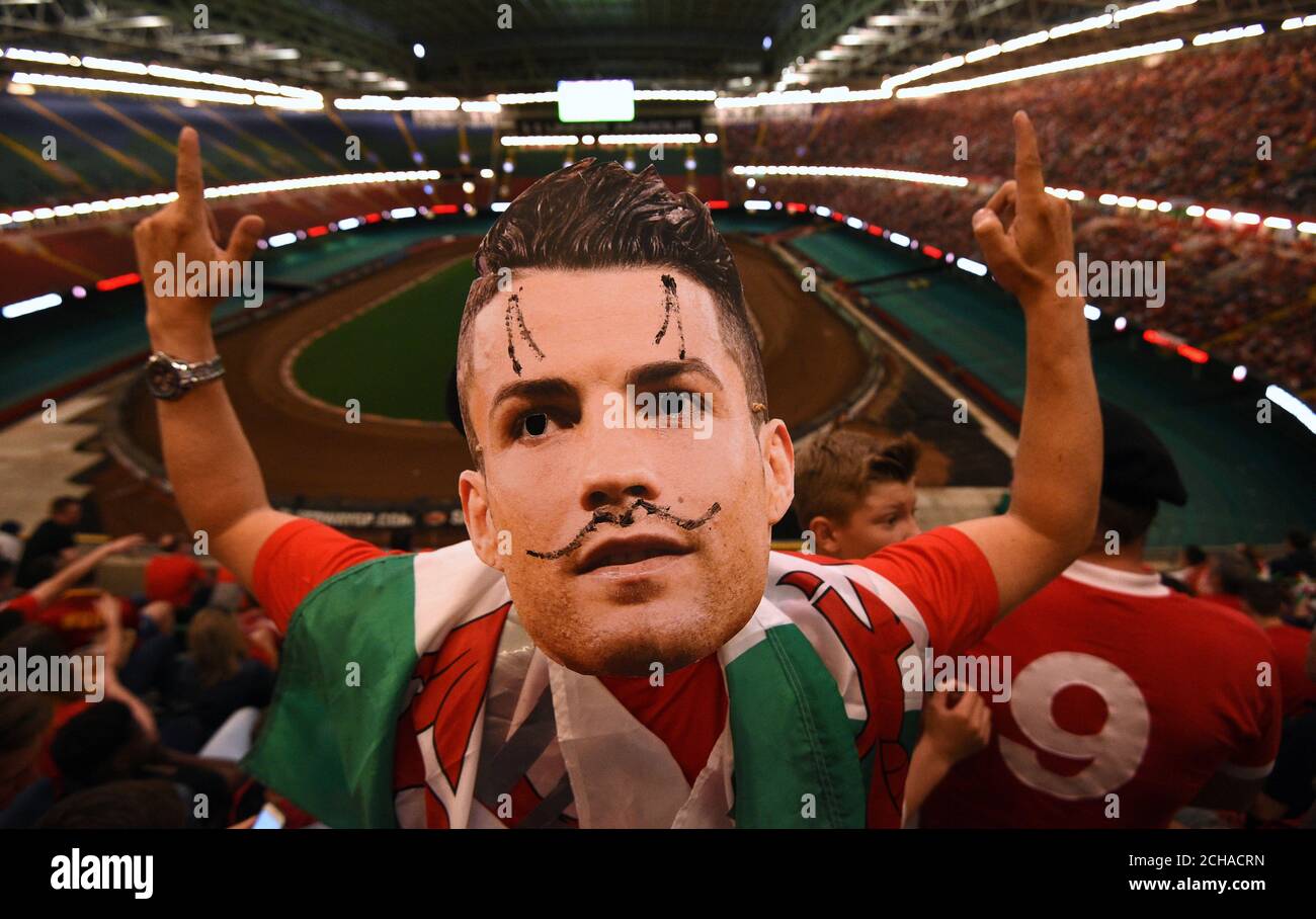 A Wales fan wearing a Cristiano Ronaldo mask watches the UEFA Euro 2016 ...