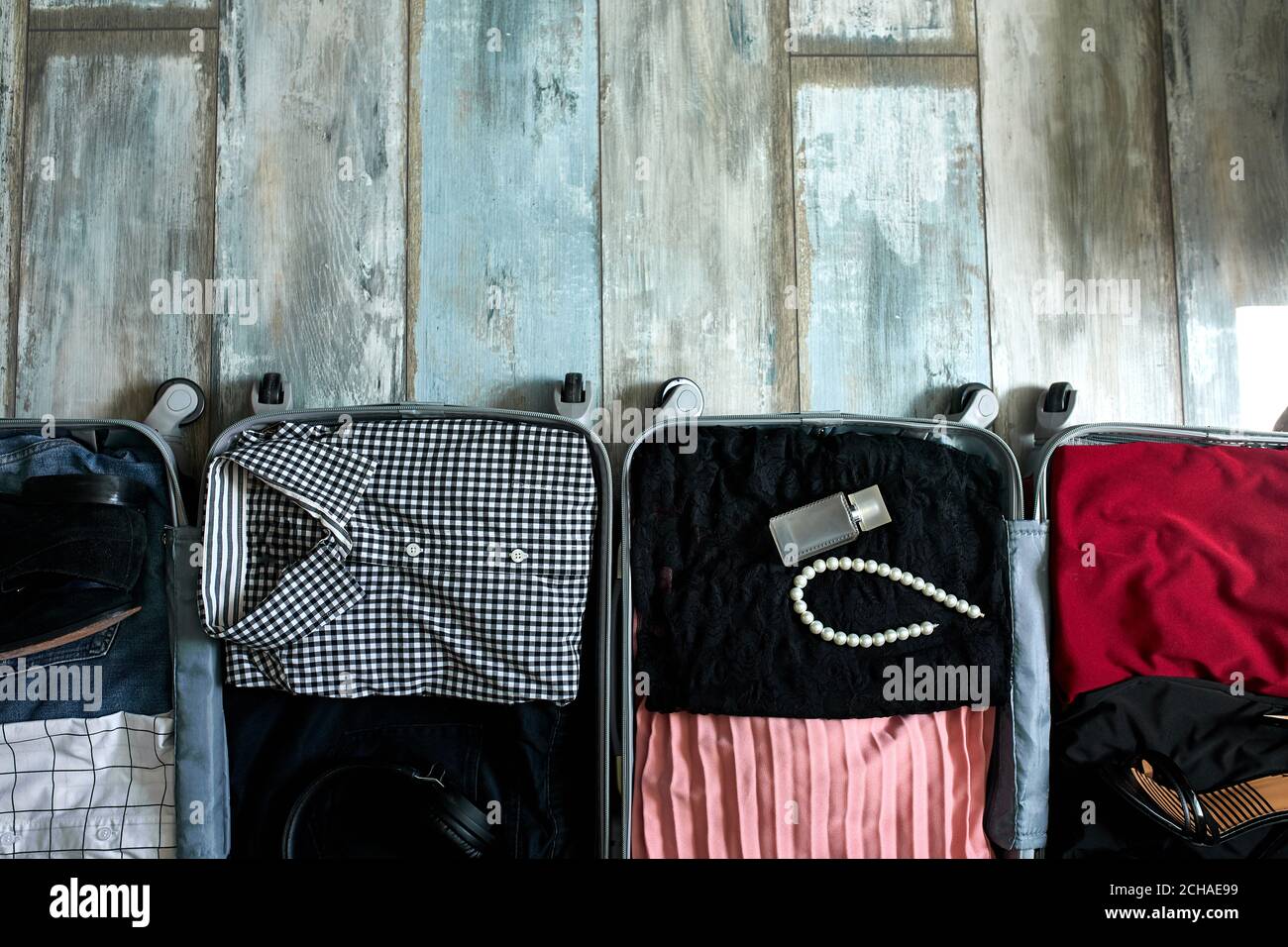 Open couple suitcase with clothing and accessories, travel and ...