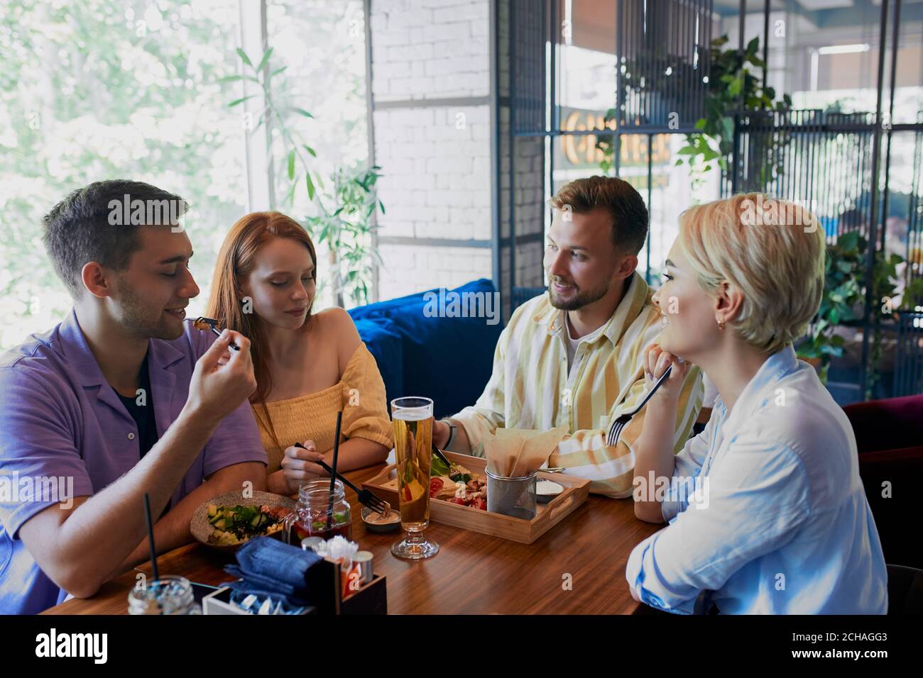 Two people chatting laughing table hi-res stock photography and images ...