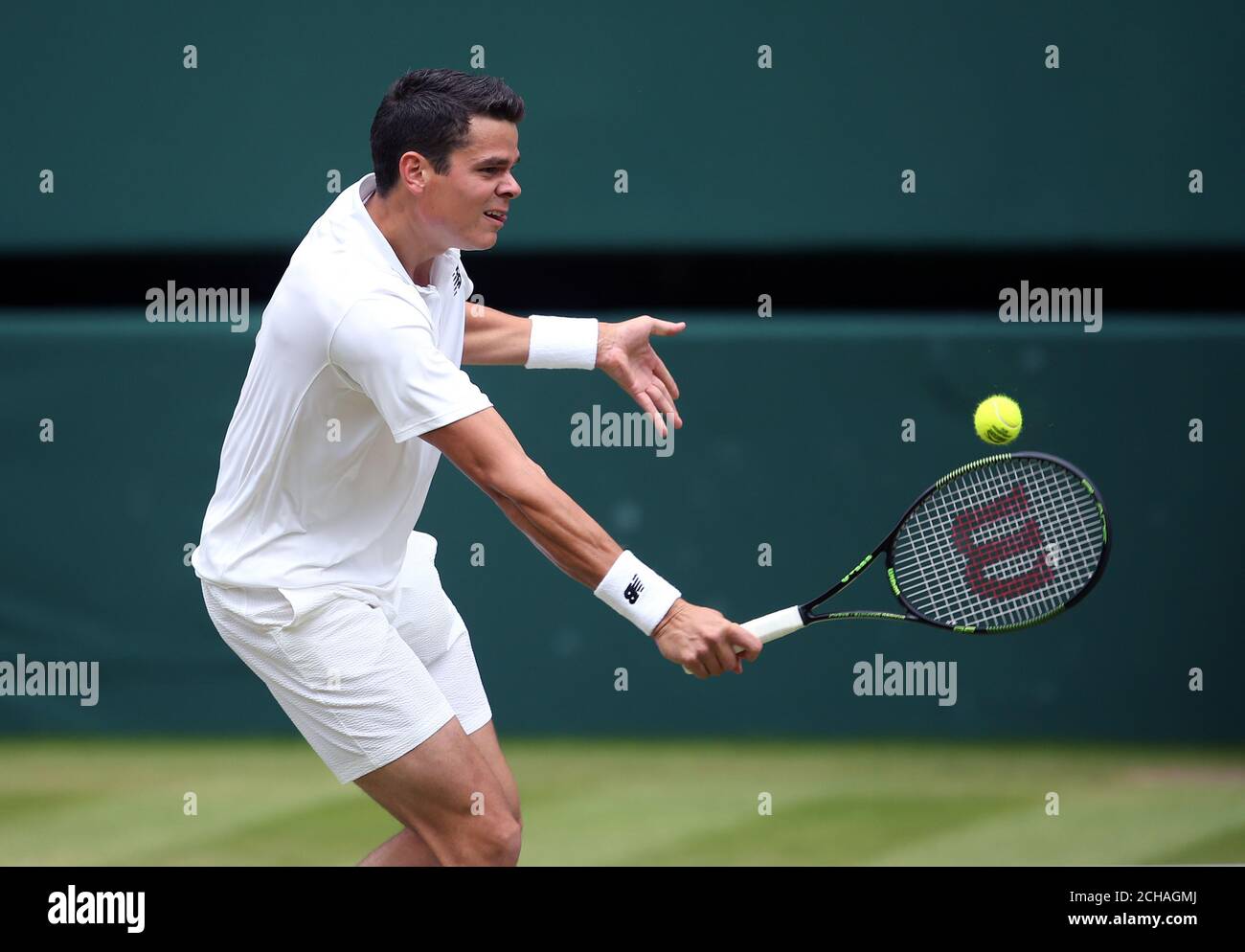 Milos Raonic in action against Roger Federer on day eleven of the ...