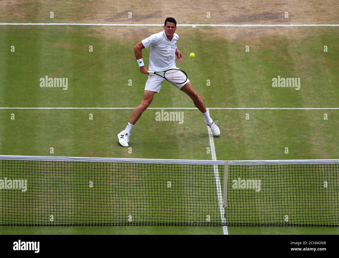 Milos Raonic in action against Roger Federer on day eleven of the ...