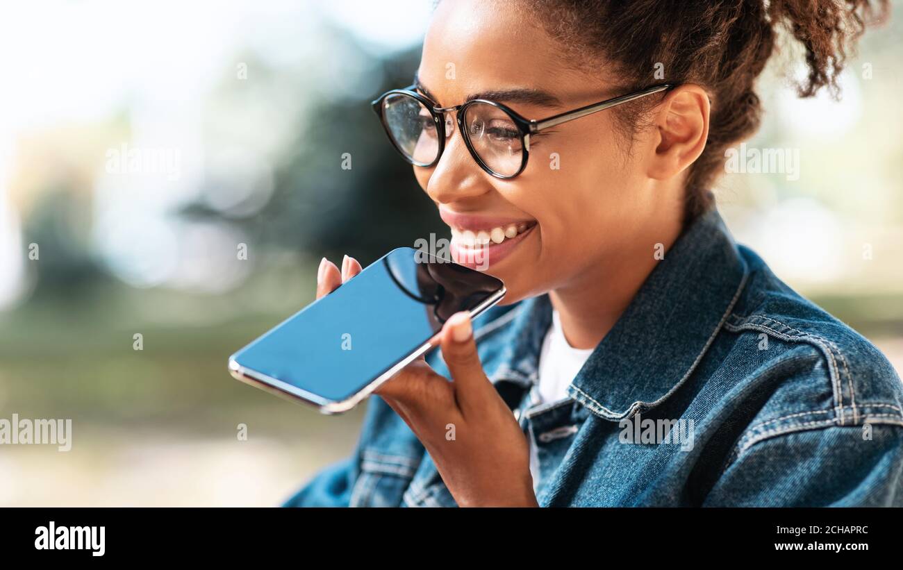 Black Woman With Smartphone Making Call Using Loudspeaker Mode Outdoors ...