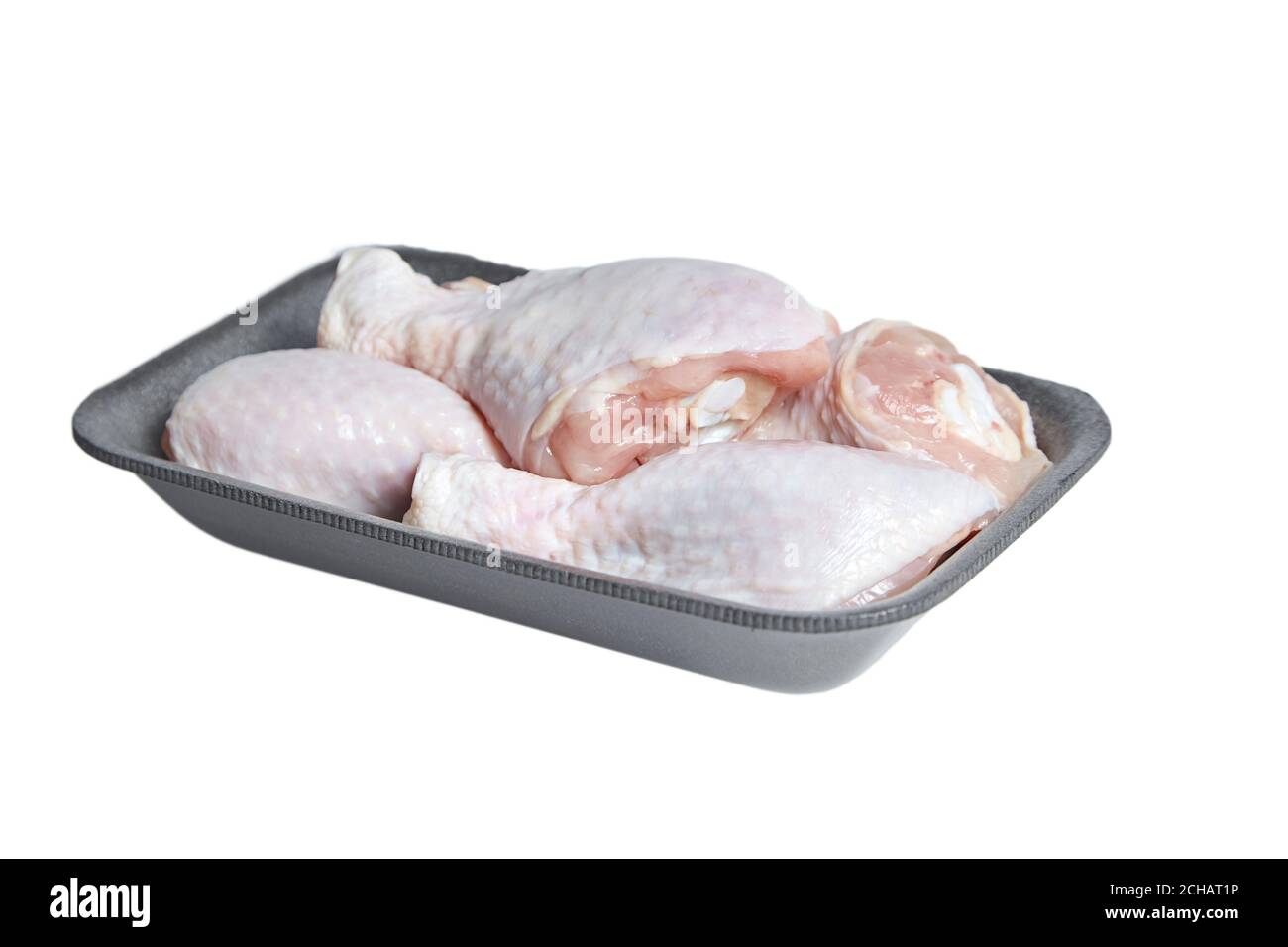 Uncooked chicken legs with skin in a grey plastic container. Fresh meat ...