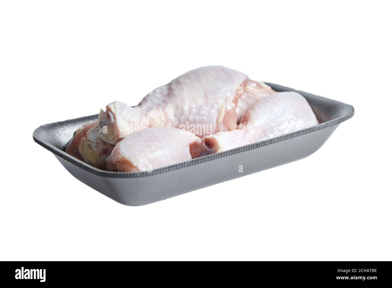 Uncooked chicken legs with skin in a grey plastic container. Fresh meat ...