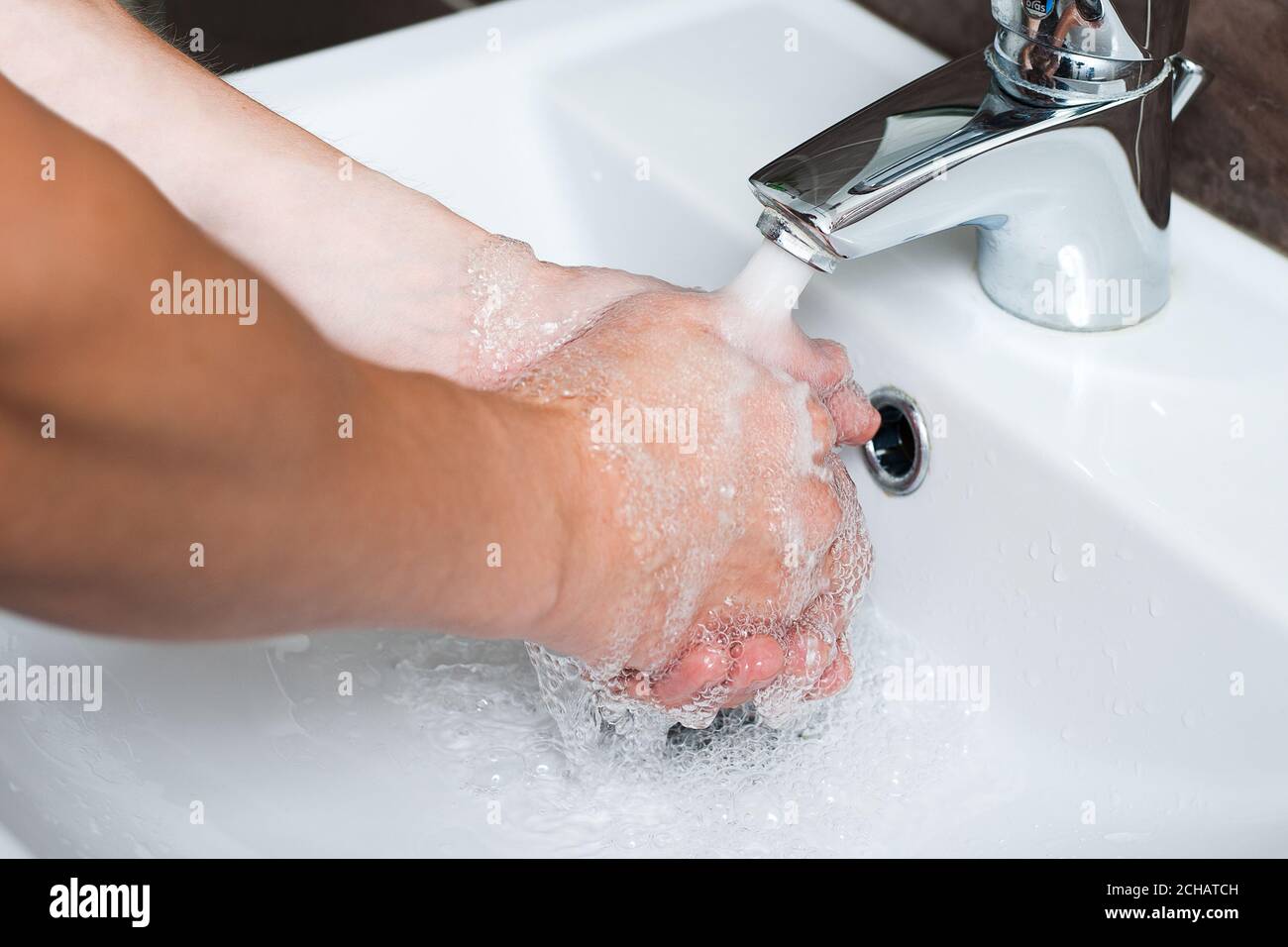 Washing hands under the water tap or faucet without soap. Hygiene ...