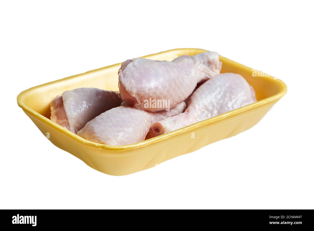 Uncooked chicken legs with skin in a yellow plastic container. Fresh ...