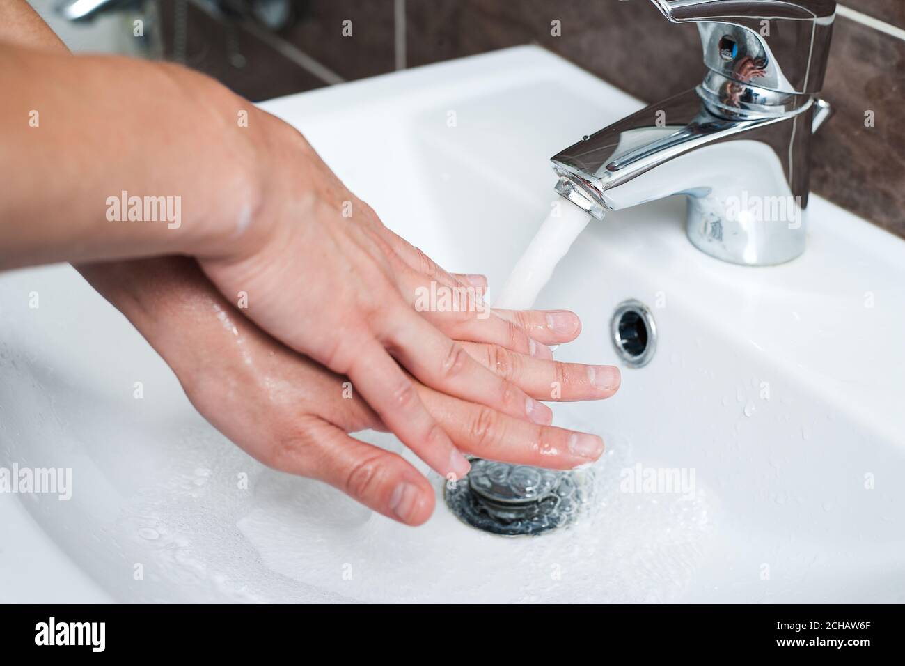 Washing hands under the water tap or faucet without soap. Hygiene ...
