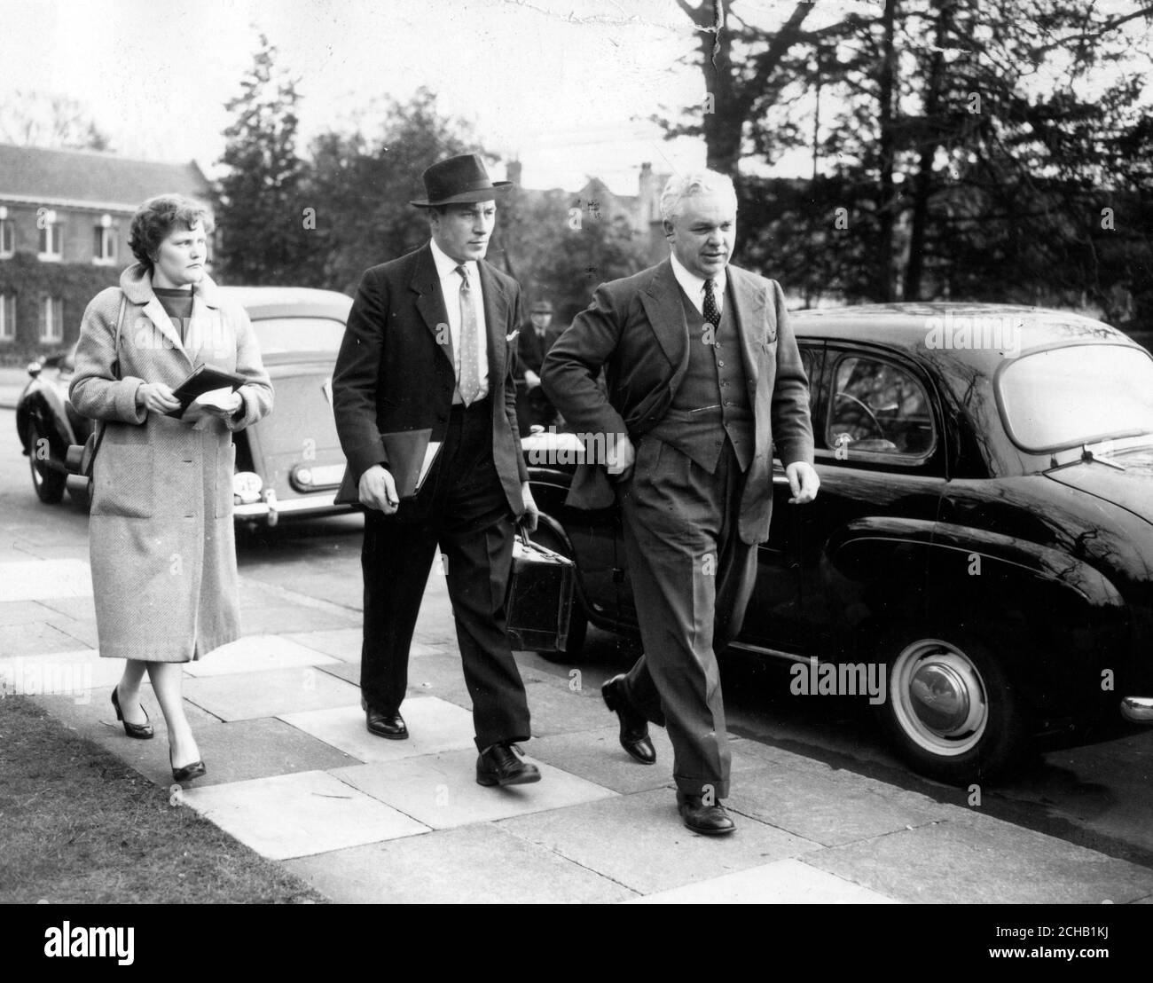 Pathologist Donald Teare (r), followed by his female secretary, leaves ...