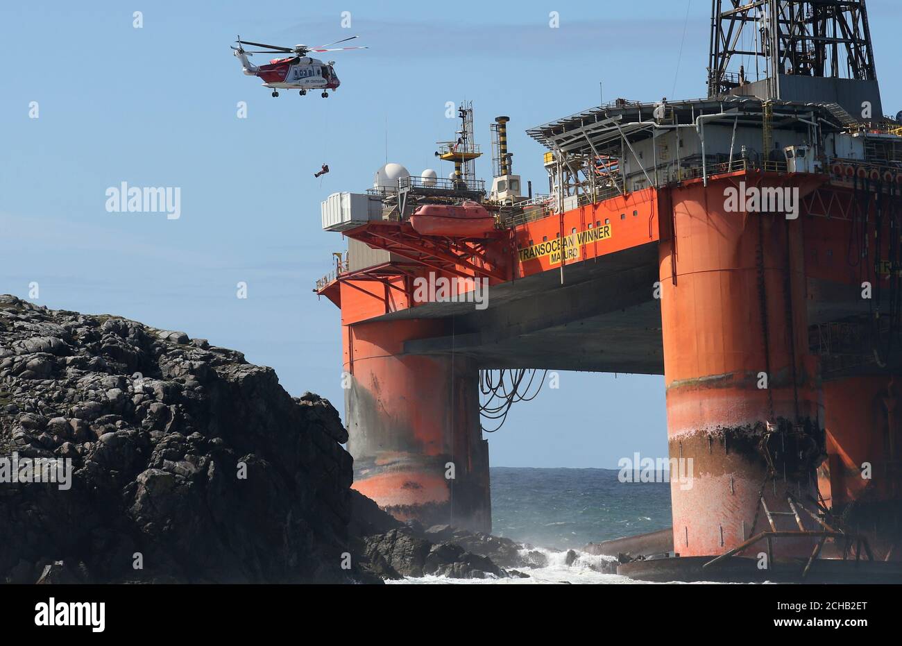 A coastguard helicopter winches a salvage expert onboard the 17000 ...