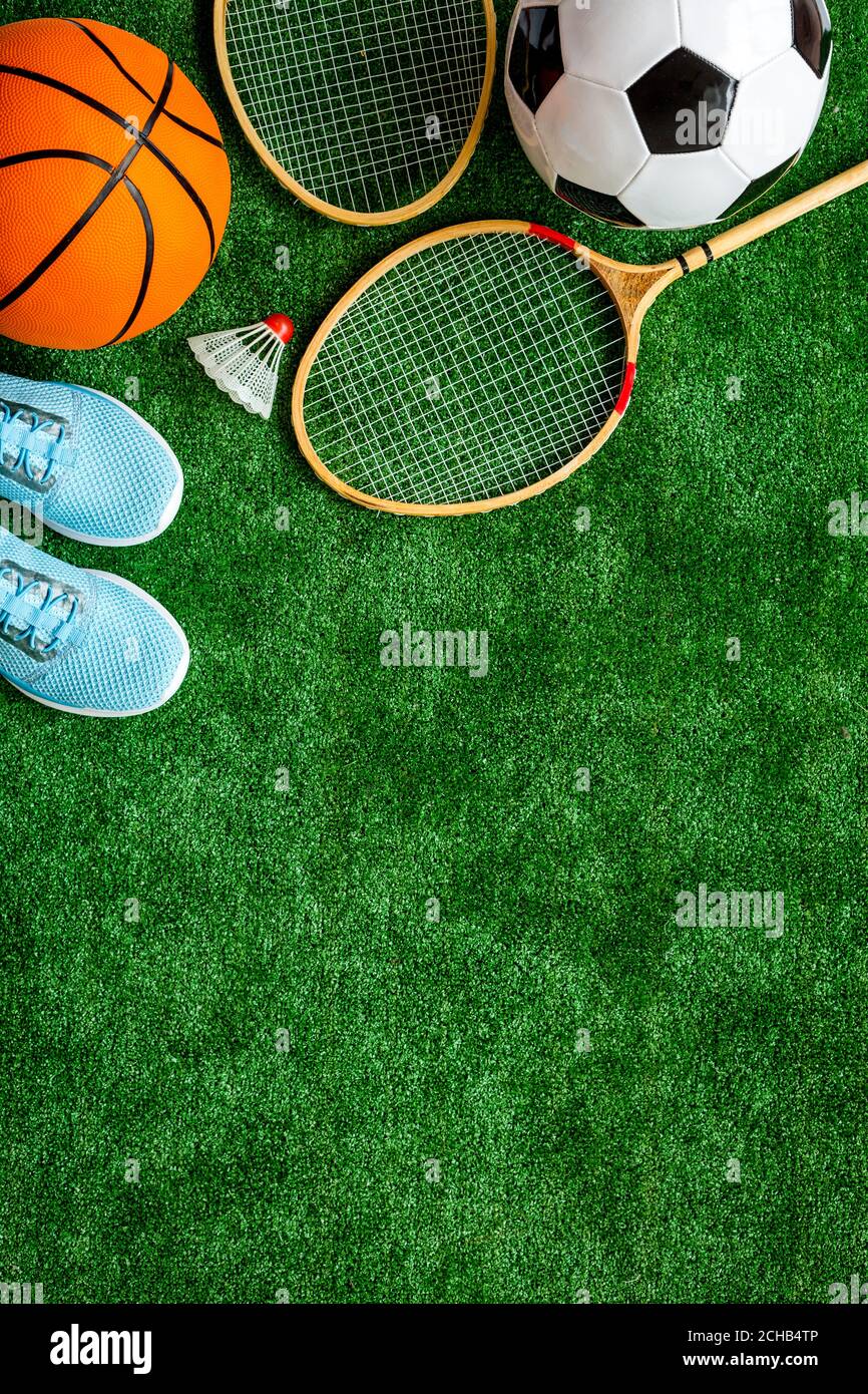 Sport games equipment on football field - balls, sneakers, rackets. Top ...