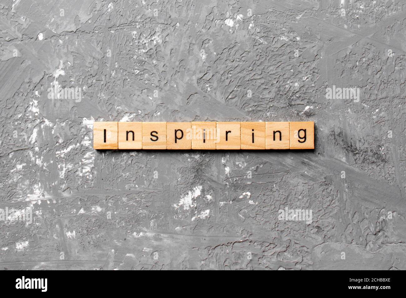 inspiring word written on wood block. inspiring text on table, concept ...