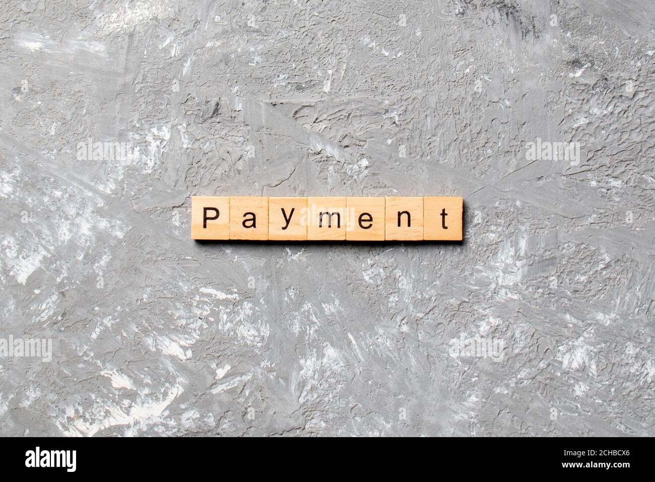 Payment word written on wood block. Payment text on cement table for ...