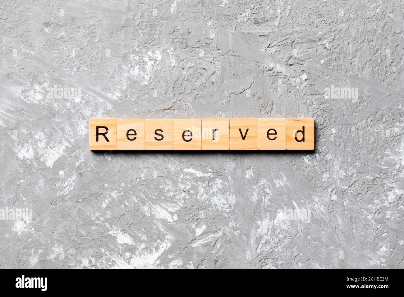 reserved word written on wood block. reserved text on cement table for ...