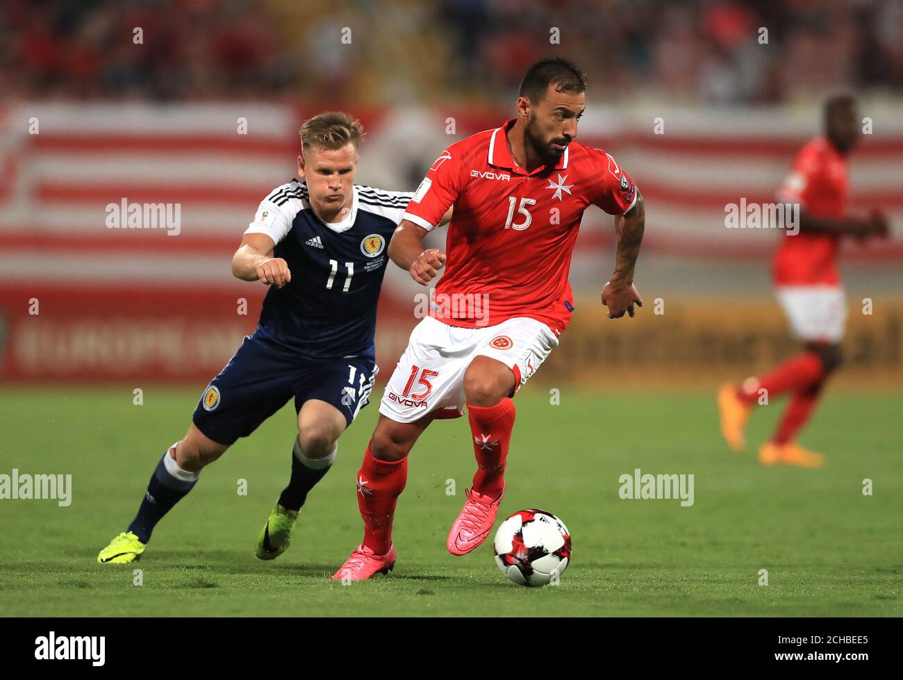 Malta's Steve Borg (right) leaves behind Scotland's Matt Ritchie Stock ...