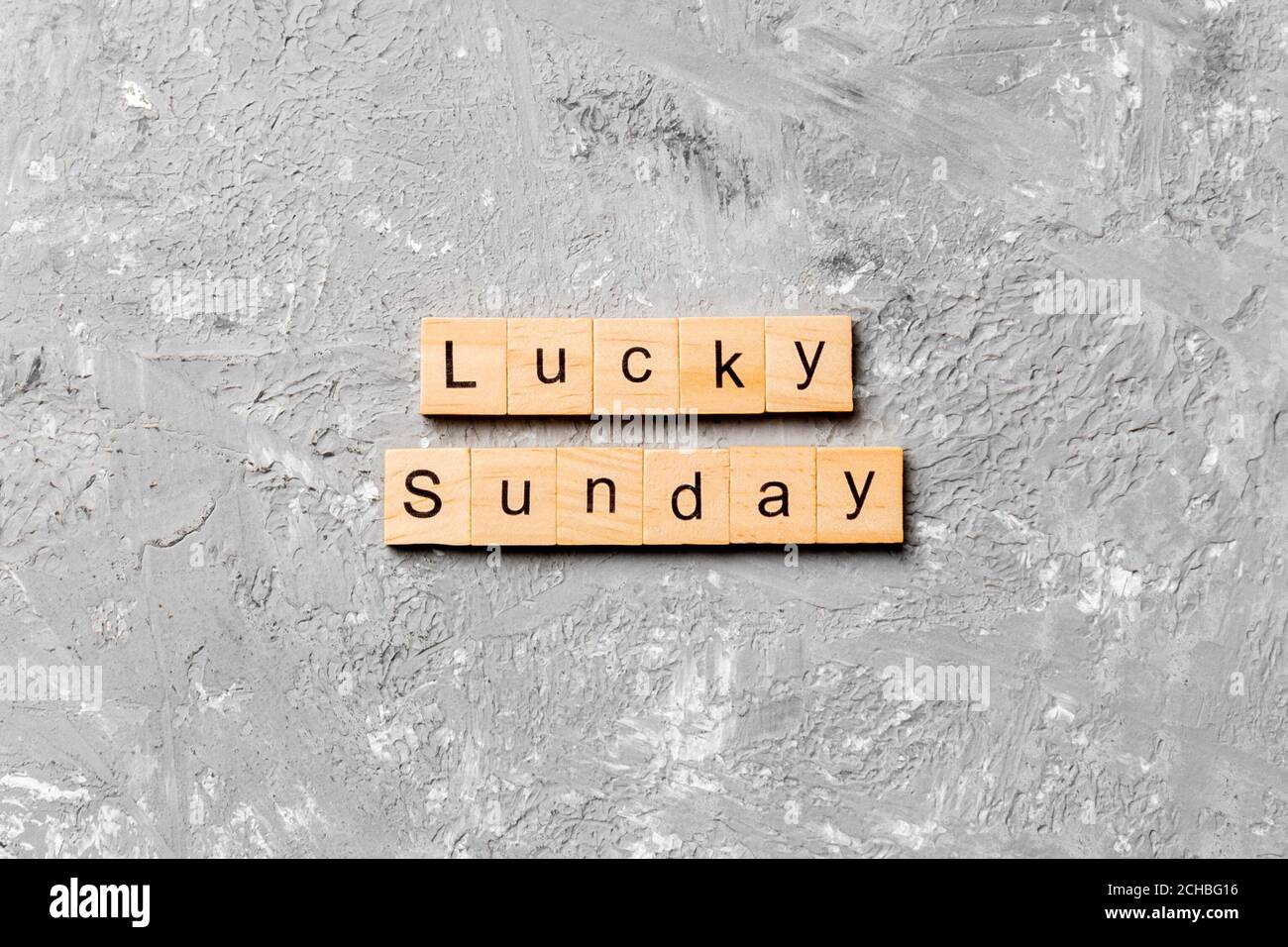 lucky sunday word written on wood block. lucky sunday text on cement ...