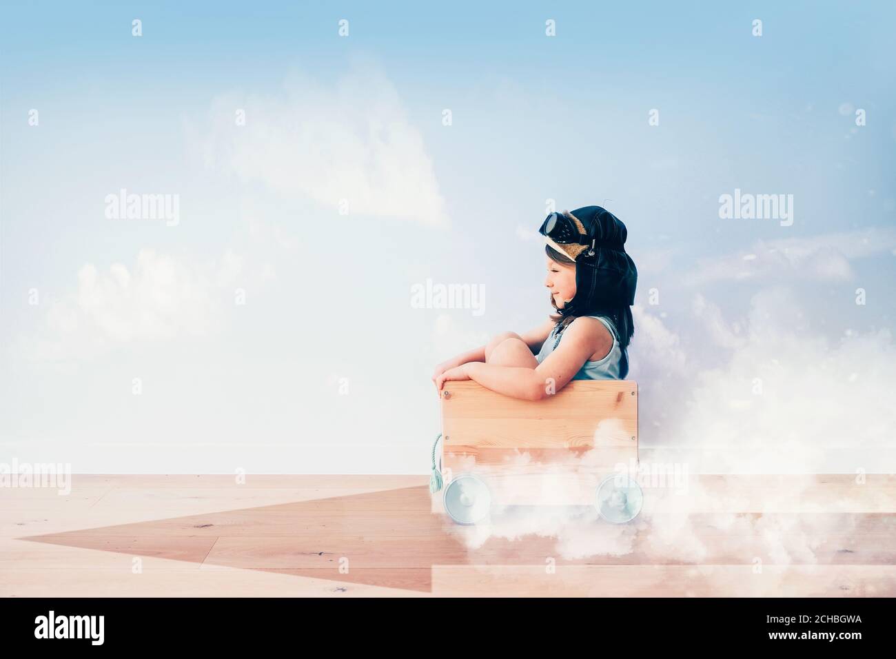 happy kid girl racing fast to her future in a wood car box - life ...