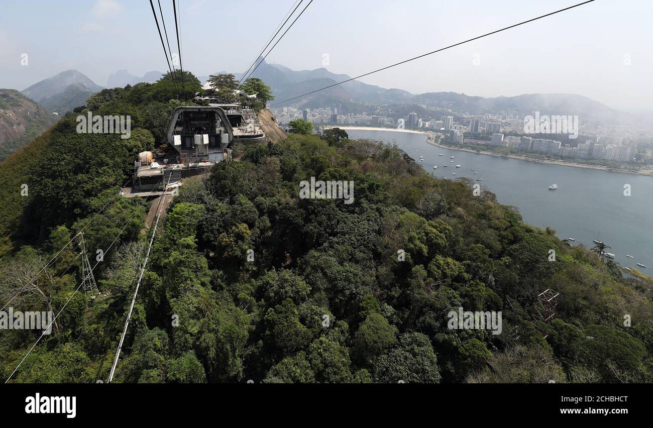A cable car makes it's way up to the top of Sugarloaf mountain from ...