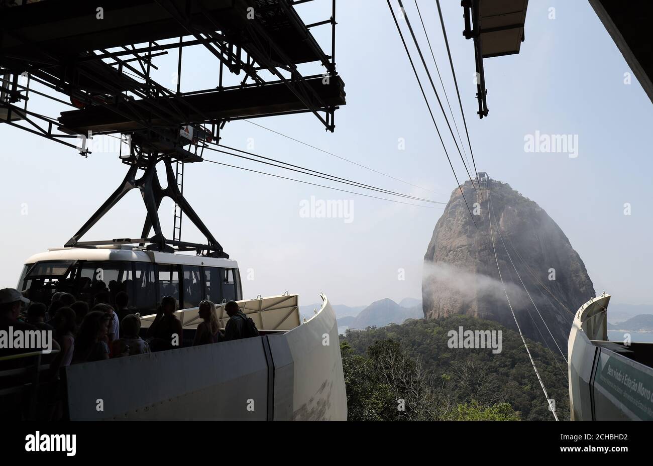 A cable car makes it's way up to the top of Sugarloaf mountain from ...